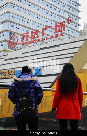 --FILE--Pedestrians walk past a Wanda Plaza of Dalian Wanda Commercial ...