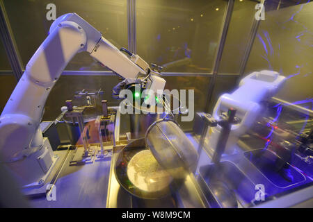 Robots Koya and Kona cook a bowl of noodles at a ramen restaurant in ...