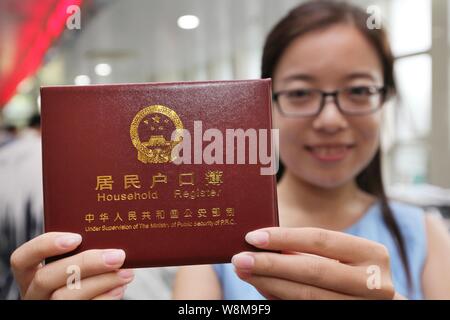 --FILE--A local Chinese resident shows his household register, also ...