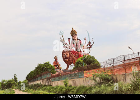 The giant statue of Durga at the Hindu temple Ganga Talao, Grand Bassin ...