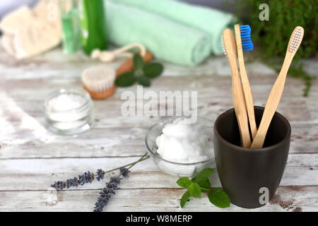 Bamboo wood toothbrush in mint color cup on purple check pattern fabric ...