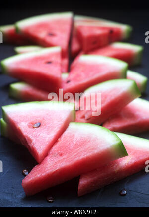 Fresh watermelon triangular slices as background or texture for summer ...