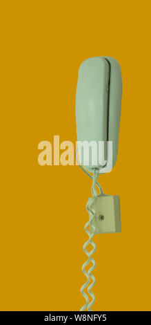 Old telephone on yellow background with copy-space Stock Photo - Alamy