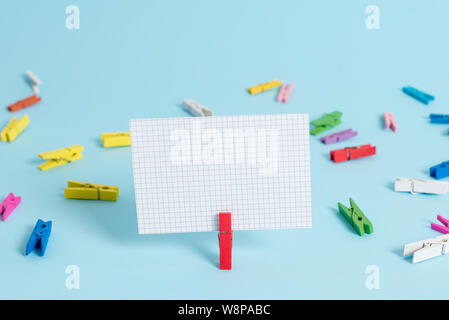 Colored clothespin rectangle square shaped paper light blue background ...