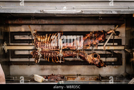 Beef on a spit roasting Stock Photo - Alamy
