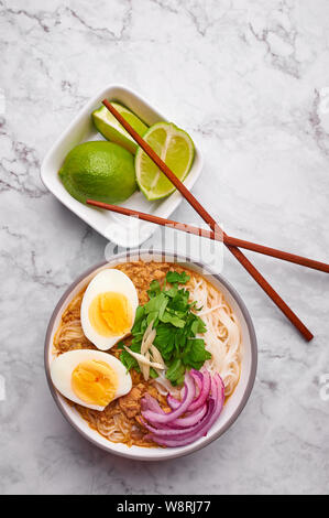 Mohinga at white marble background. Mohinga is a burmese cuisine fish ...