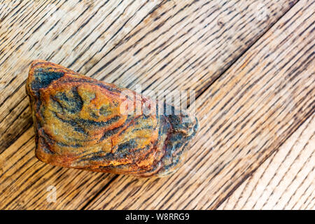 Colorful rainbow stone on rustic wood background Stock Photo - Alamy