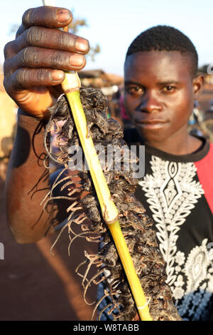 Market vendor sells mice on a market in a remote village near Dedza ...