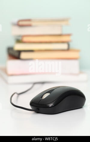 Stack of books connected with a computer mouse Stock Photo - Alamy