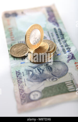 Pile of Indian Rupee Coins. Ten rupee coins stacked in stacks. On a ...