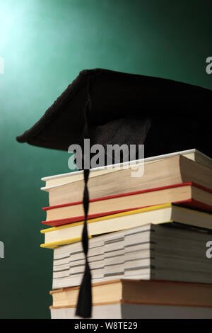 Mortar board on a stack of books Stock Photo - Alamy