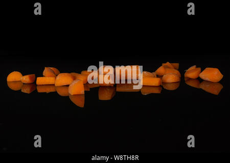 Lot of pieces of stale orange stale baby carrot baby in wooden cup ...