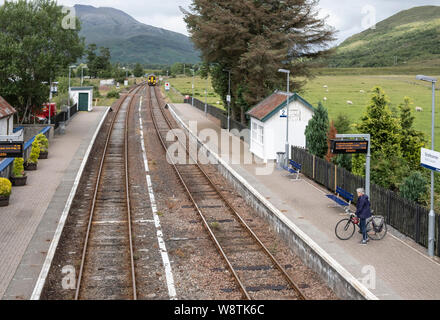 Passenger with bicycle for ScotRail train at Strathcarron Station ...