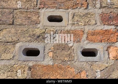 Swift nesting brick in wall of cottage with faecal sac in entrance ...