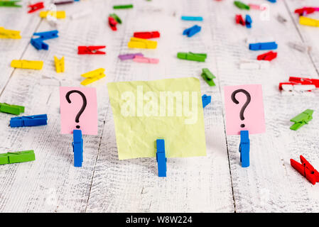 Scribbled and crumbling sheet with paper clips placed on the wooden ...