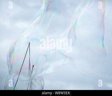 Blowing large soap bubbles against blue sky Stock Photo - Alamy