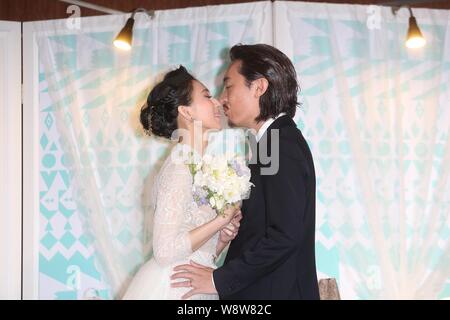 Malaysian singer Penny Tai, left, poses with her Taiwanese husband ...