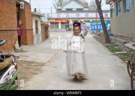 47-year-old Chinese villager Xiang Junfeng, dressed in a red wedding ...