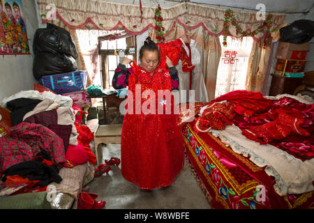47-year-old Chinese villager Xiang Junfeng, dressed in a white wedding ...