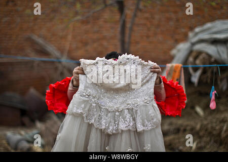 47-year-old Chinese villager Xiang Junfeng, dressed in a white wedding ...