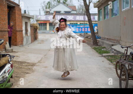 47-year-old Chinese villager Xiang Junfeng, dressed in a white wedding ...