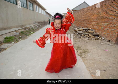 47-year-old Chinese villager Xiang Junfeng, dressed in a white wedding ...