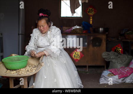 47-year-old Chinese villager Xiang Junfeng, dressed in a white wedding ...