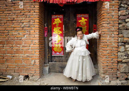 47-year-old Chinese villager Xiang Junfeng, dressed in a white wedding ...