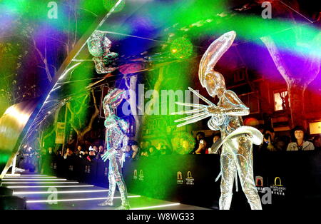 Entertainers dressed in alien-style costumes perform during the Design Your Style crossover ...