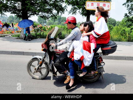Chinese girls on electric bike at night. Electric bikes are swarming on ...