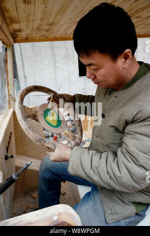 Chinese carpenter Liu Fulong assembles his homemade electric wooden ...