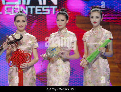 Chinese and foreign models display creations of cheongsam, also known ...