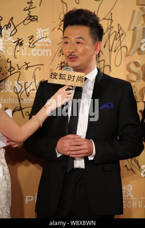--FILE--Chinese actor Huang Haibo poses on the red carpet as he arrives ...