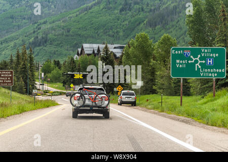 Vail road highway through Colorado towns with sign for ski area in ...