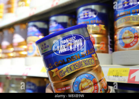 --FILE--A customer shops for a tin of Firmus milk powder of Feihe Dairy ...