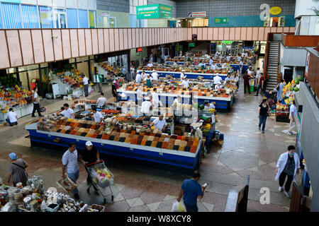 Indoor market / bazaar in almaty, kazakhstan. A kazakh woman and man ...