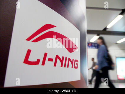 --FILE--Pedestrians walk past a Li-Ning sportswear store in Beijing ...