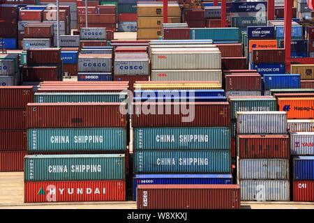 FILE - Shipping containers are stacked at a port in Tianjin, China ...