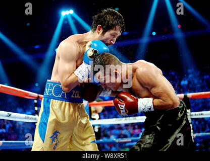 Luis De La Rosa of Colombia, left, hits Zou Shiming of China in their ...