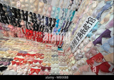 56-year-old Chen Qingzu shows a bra inside his bra museum in Yacheng ...