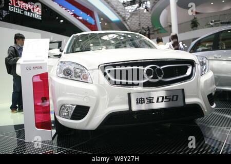 --FILE--Visitors look at BAIC and Mercedes-Benz cars on display at the ...