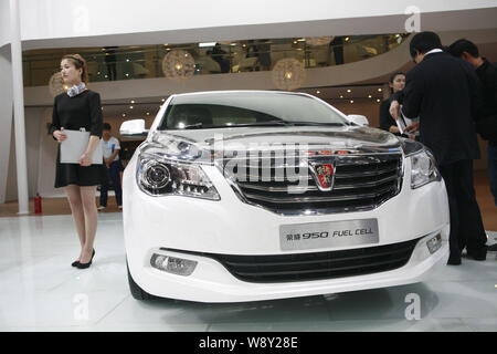 Visitors look at a Roewe 950 Fuel Cell of SAIC Motor during the 13th ...