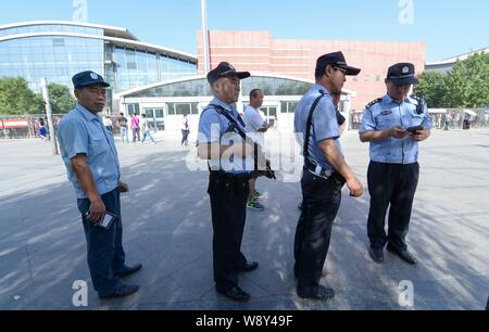 Police officers stand guard at a check point at a street near the venue ...