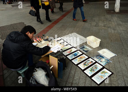 Chinese handicapped artist Zhang Qihui, who lost his left arm and four ...