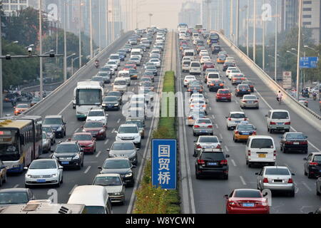 Masses of vehicles overcrowd a road in a traffic jam during rush hour ...