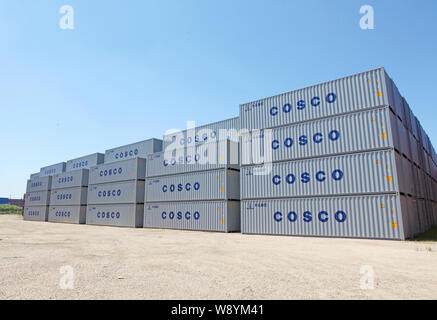 FILE - Shipping containers are stacked at a port in Tianjin, China ...