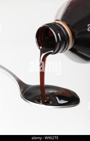 Close up of cough syrup being poured in spoon Stock Photo - Alamy