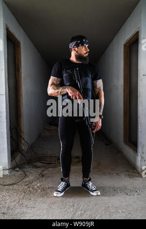 A character from an Airsoft game is depicted, holding an M15 gun ...