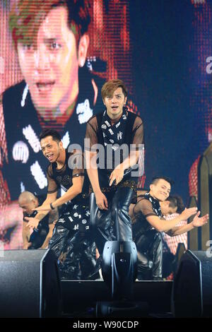 Taiwanese singer Show Lo, center, performs during his Show Lo 2014 Over ...