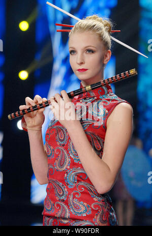 A foreign model displays a creation of cheongsam, also known as qipao ...